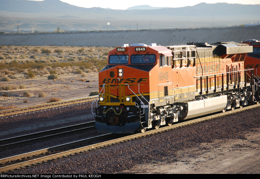 With the Sun shining off Her BNSF/GE Swoosh Logo Paint BNSF 6949 heads west at 0700 am.
